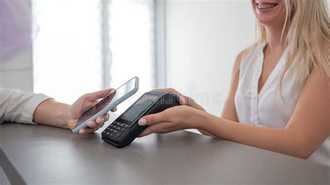 A Woman Pays Using A Non Contact Payment Of The Nfc Used By A Smartphone Stock Photo Image