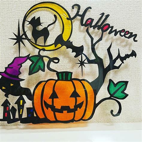 A Halloween Scene With Pumpkins And Witches On The Side Of A White Wall