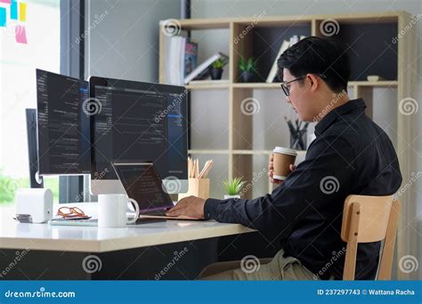 Asian Man Programmer Working At At Modern Office Developing