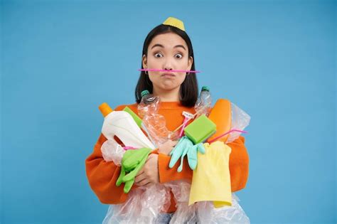 Premium Photo Portrait Of Cute Girl Blowing Bubbles Against Blue