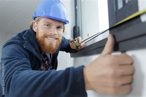 Man Measuring Window Prior To Installation Of Roller Shutter Outdoors Stock Photo Adobe Stock