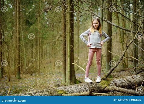 Cute Young Girl Having Fun During Forest Hike On Beautiful Early Spring