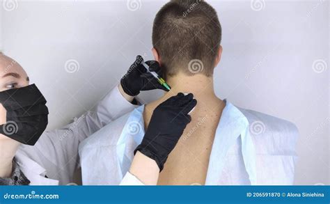 An Orthopedic Surgeon Gives An Injection In The Cervical Vertebrae Treatment Of Osteoarthritis