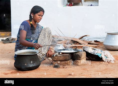 Young Indian Wife In A Rural Village Making Chapati On An Open Fire
