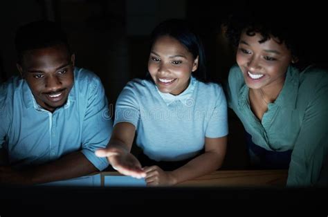 The Night Is Alive With Possibilities A Group Of Young Businesspeople Using A Computer Together