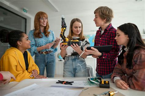 A Group Of Students Building And Programming Electric Toys And Robots