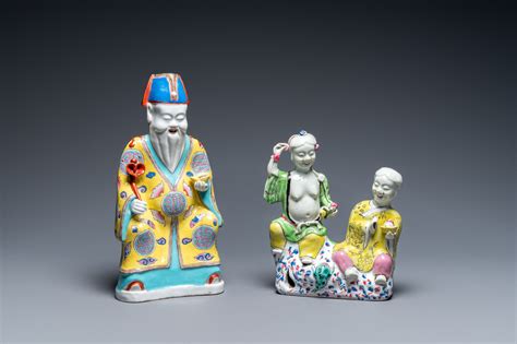 A Chinese Famille Rose Hehe Er Xian Group And A Caishen Figure