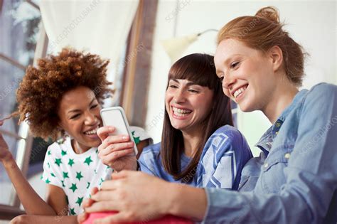 Three Female Friends Using Smartphone Stock Image F009 2955
