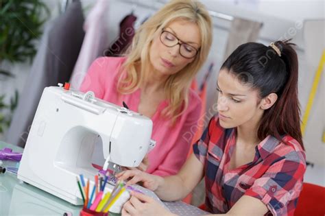 Two Young Beautiful Female Tailors Working In The Tailor Shop Photo