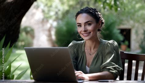 Adult Woman Sitting In Front Of A Computer Laptop And Working Smiling