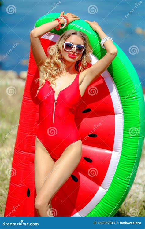 Woman In Swimsuit And Sunglasses With A Figure Of A Sex Symbol Stock Image Image Of Enjoyment