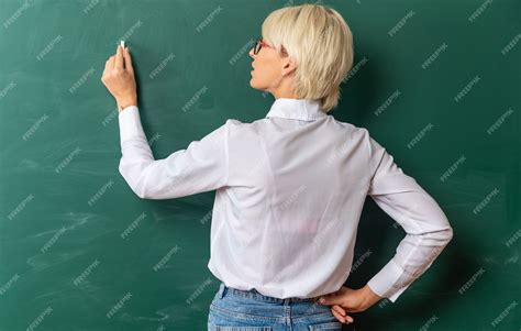 Free Photo Concentrated Young Blonde Female Teacher Wearing Glasses