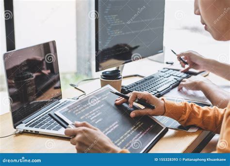 Programmers Cooperating At Developing Programming And Website Working In A Software Develop