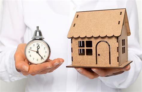 손에 집 모델과 시계 모기지 또는 임대 부동산에 대한 적시 지불의 개념 모델 하우스 모형에 대한 스톡 사진 및 기타 이미지