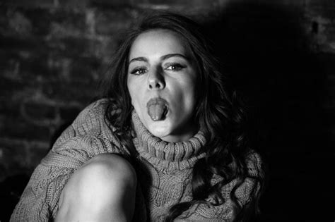 Premium Photo A Woman Sticks Her Tongue Out To The Camera