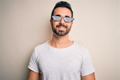 Young Handsome Man With Beard Wearing Funny Thug Life Sunglasses Over