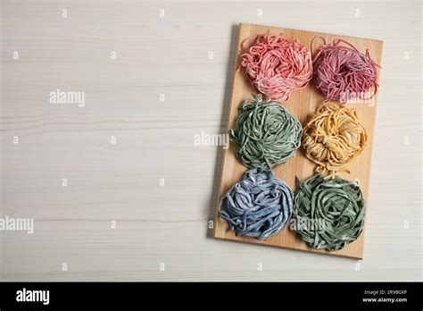Rolled Pasta Painted With Food Colorings On White Wooden Table Top