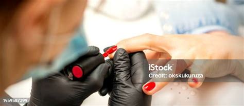 매니큐어 바니시 그림 미용실에서 여성 손톱에 빨간 바니시를 바르는 고무 검은 장갑을 낀 매니큐어 마스터의 클로즈업 네일 살롱에 대한 스톡 사진 및 기타 이미지 Istock