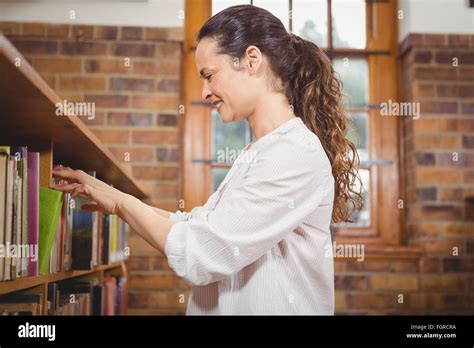Librarian Sorting Books On The Shelves Stock Photo Alamy