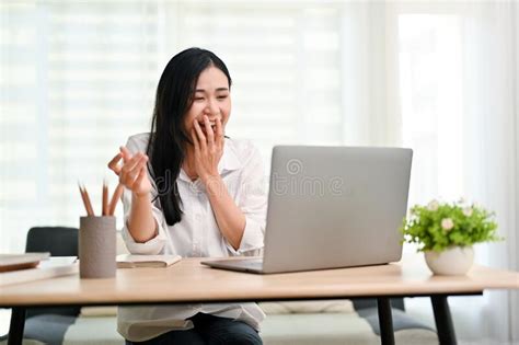 Excited Shocked And Cheerful Asian Businesswoman Looking At Her Laptop Screen Stock Image
