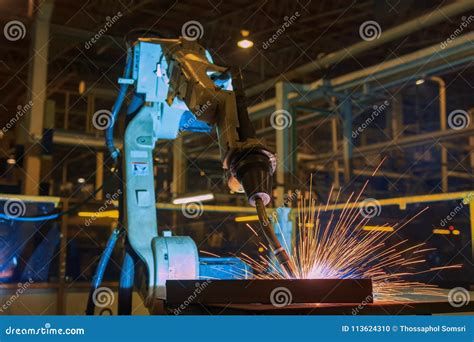 Industrial Robot Welding Are Movement Welding Car Part In Automotive Industrial Factory Royalty
