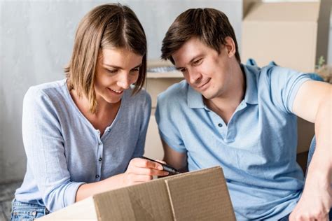 Free Photo Couple At Home On Moving Day Labeling Box