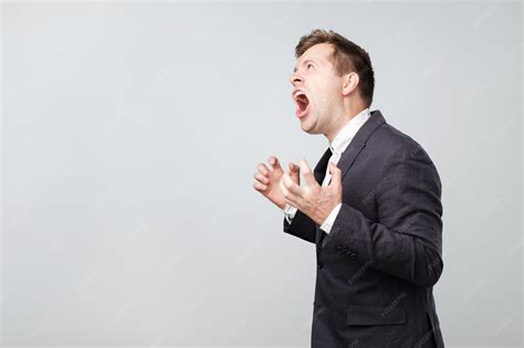 Premium Photo Side View Of Young Caucasian Man Screaming Loudly While