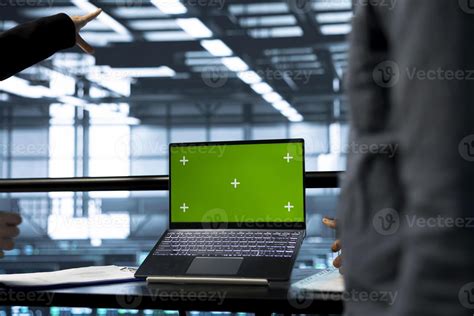 System Administrators In Data Center Using Green Screen Mockup Notebook Observing Analytics