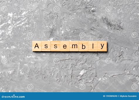 Assembly Word Written On Wood Block Assembly Text On Cement Table For