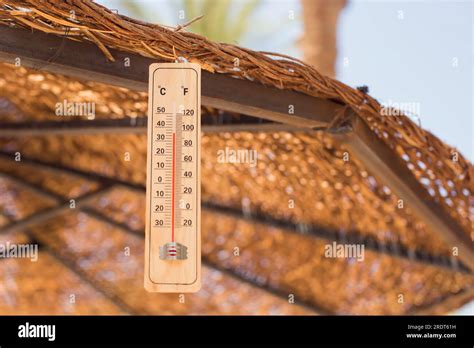 Thermometer On A Parasol Showing High Temperature Hot Weather And