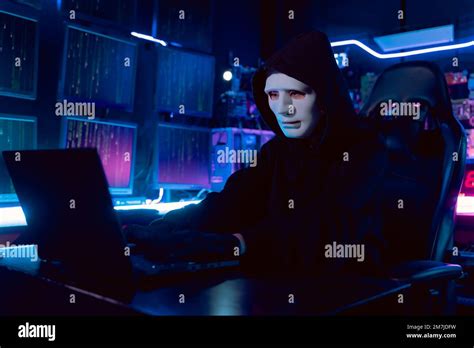 Female Asian Hacker In Hideout Place With Dark Environment And Multiple