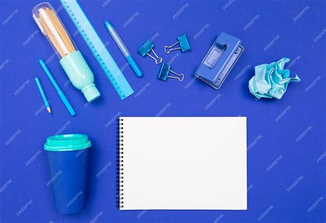 Premium Photo Design Concept Blank Sketchbook With Accessories On A Blue Background With A Layout