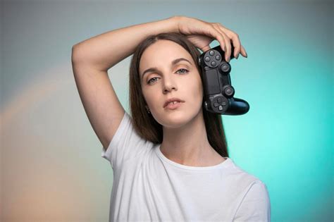 Premium Photo Beautiful Woman Holding Console Controller On Colorful Background Young Adult