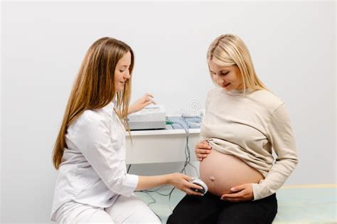 Woman Pregnant Checking Fetal Heart Beat By Fetal Monitoring Expectant Mother With Midwife