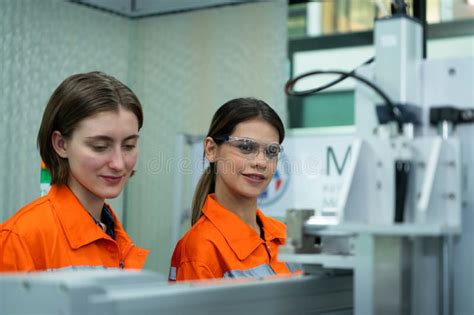 Both Of Woman In An Electronic Parts Factory Using A Production Line Controller Stock Image