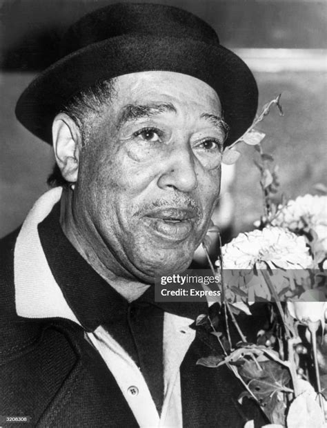 A Headshot Of Jazz Musician And Composer Duke Ellington Holding News