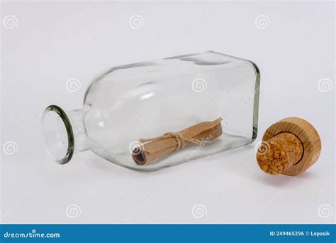 An Open Glass Bottle With An Old Note Inside On A Light Background The