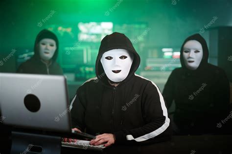 Premium Photo Masked Hacker Is Using Computer For Organizing Massive Data Breach Attack On