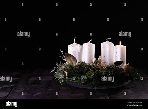 First Advent Advent Wreath From Fir And Evergreen Branches With White Burning Candles On Dark