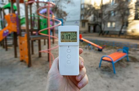 A Hand Holds A Dosimeter Radiometer Device For Measuring Radiation A Hand Holds A Dosimeter Radiometer Device For Measuring Radiation