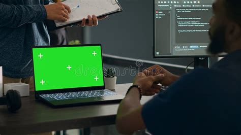 Database Admins Analyzing Source Code And Greenscreen Display On