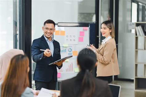 Professional Diverse Business Team Presenting And Discussing Data Charts And Graphs During