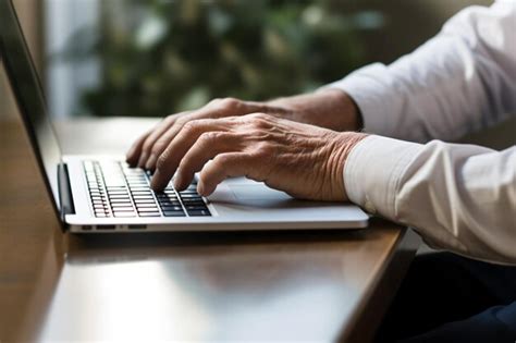 Premium Photo Elderly Typing On The Keyboard Of A Laptop Close Up On The Hands Old People