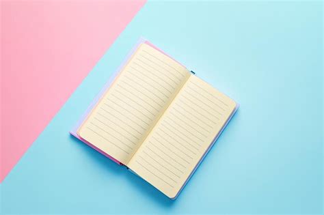 Open Notebook And Colorful Notebooks On Blue And Pink Table Premium