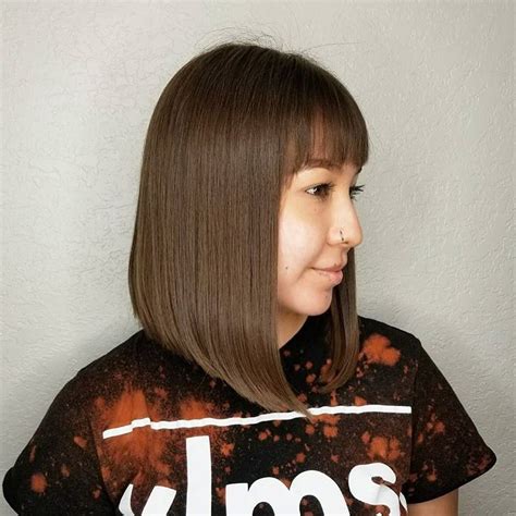 Sleek Angled Lob With Brow Skimming Bangs And Chocolate Brown Hair
