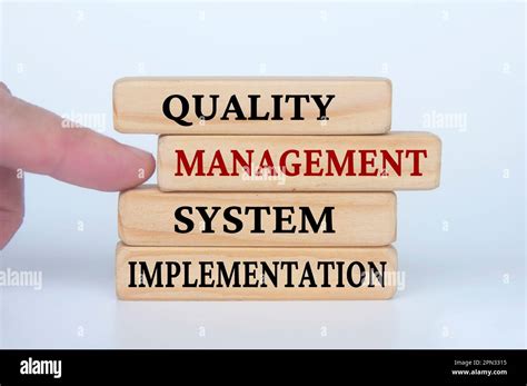 Quality Management System Implementation Text On Wooden Blocks Business Culture And Operational