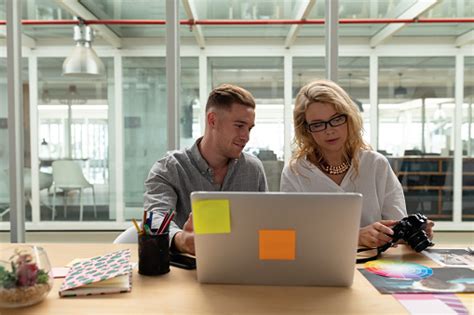 책상에서 노트북을 통해 논의 하는 남성 및 여성 그래픽 디자이너 계획에 대한 스톡 사진 및 기타 이미지 계획 귀여운 그래픽 디자이너 Istock