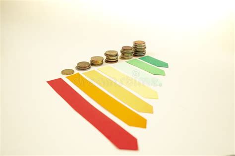 Energy Efficiency Rating Chart And Increasing Coin Stacks On Beige