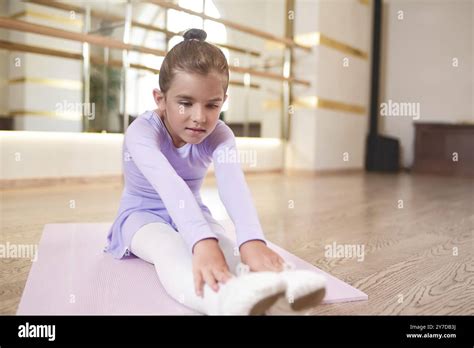 Adorable Photo Of Little Ballerina In A Lilac Dress And White Tights