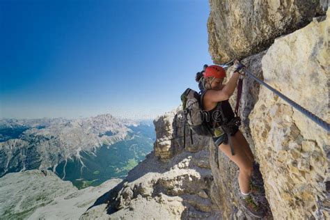 Two Women Mountain Climbers On An Exposed Via Ferrata In The Dolomites